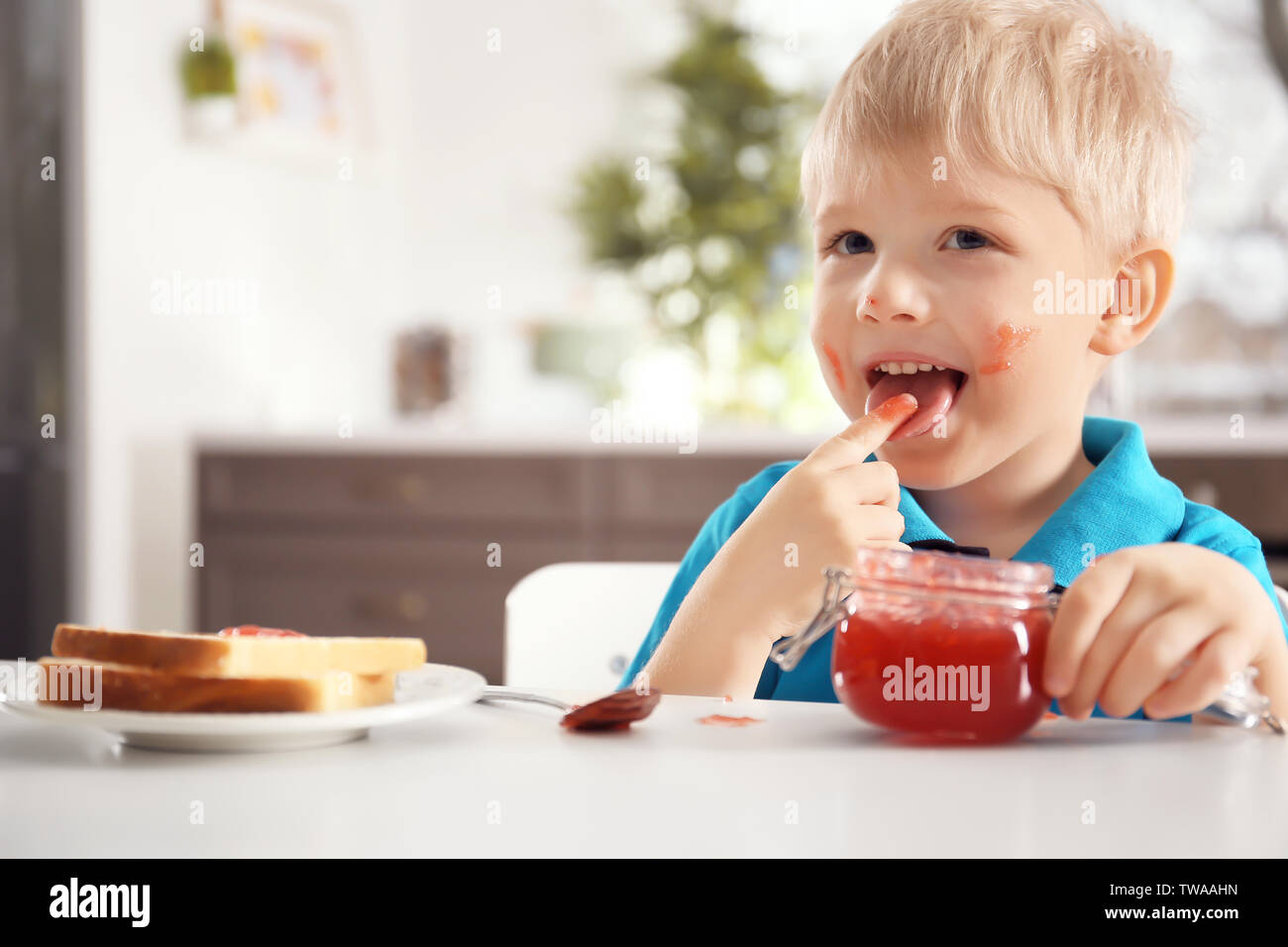 Cute little boy with jar of jam at home Stock Photo - Alamy