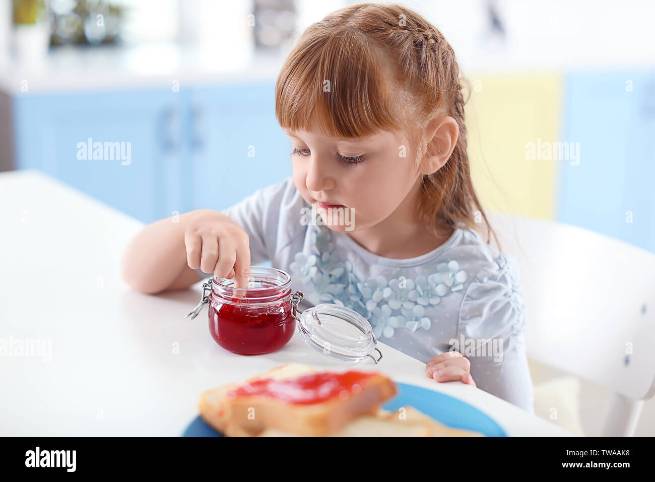 Cute little girl with jar of jam at home Stock Photo - Alamy
