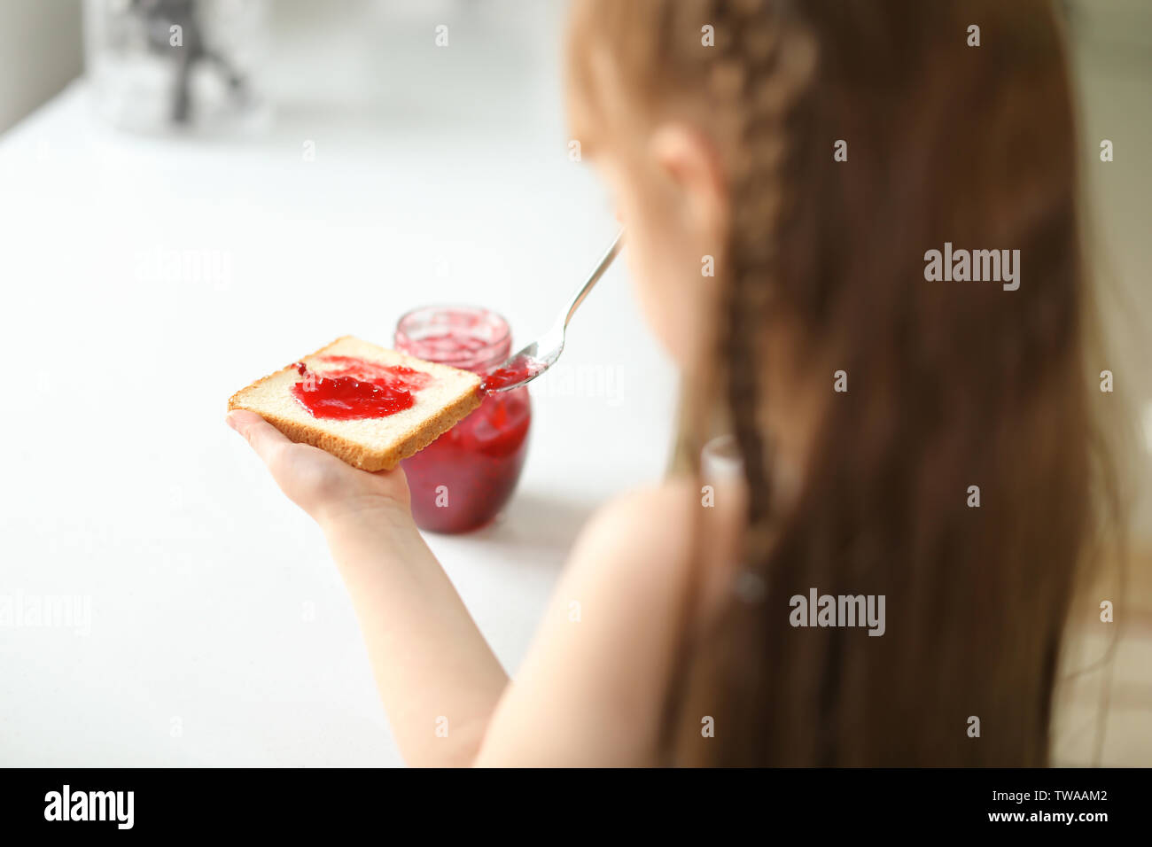 Kid eating jam on toast hi-res stock photography and images - Alamy