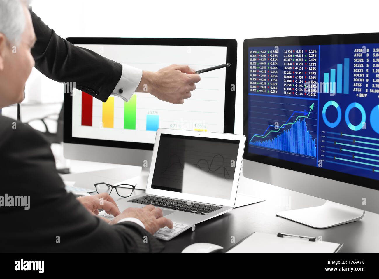 Male brokers working in office. Finance trading concept Stock Photo - Alamy