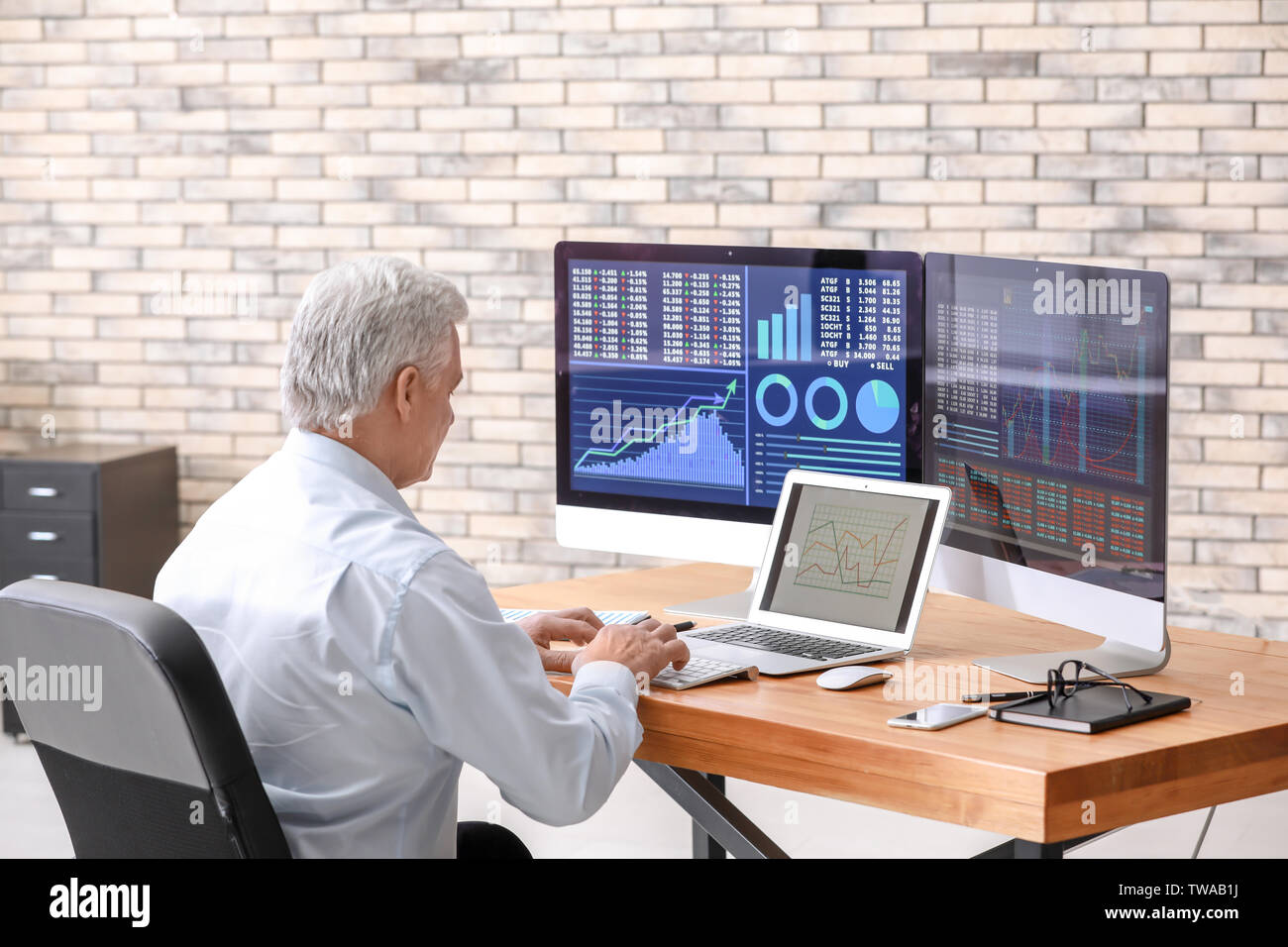 Male broker working in office. Finance trading concept Stock Photo - Alamy