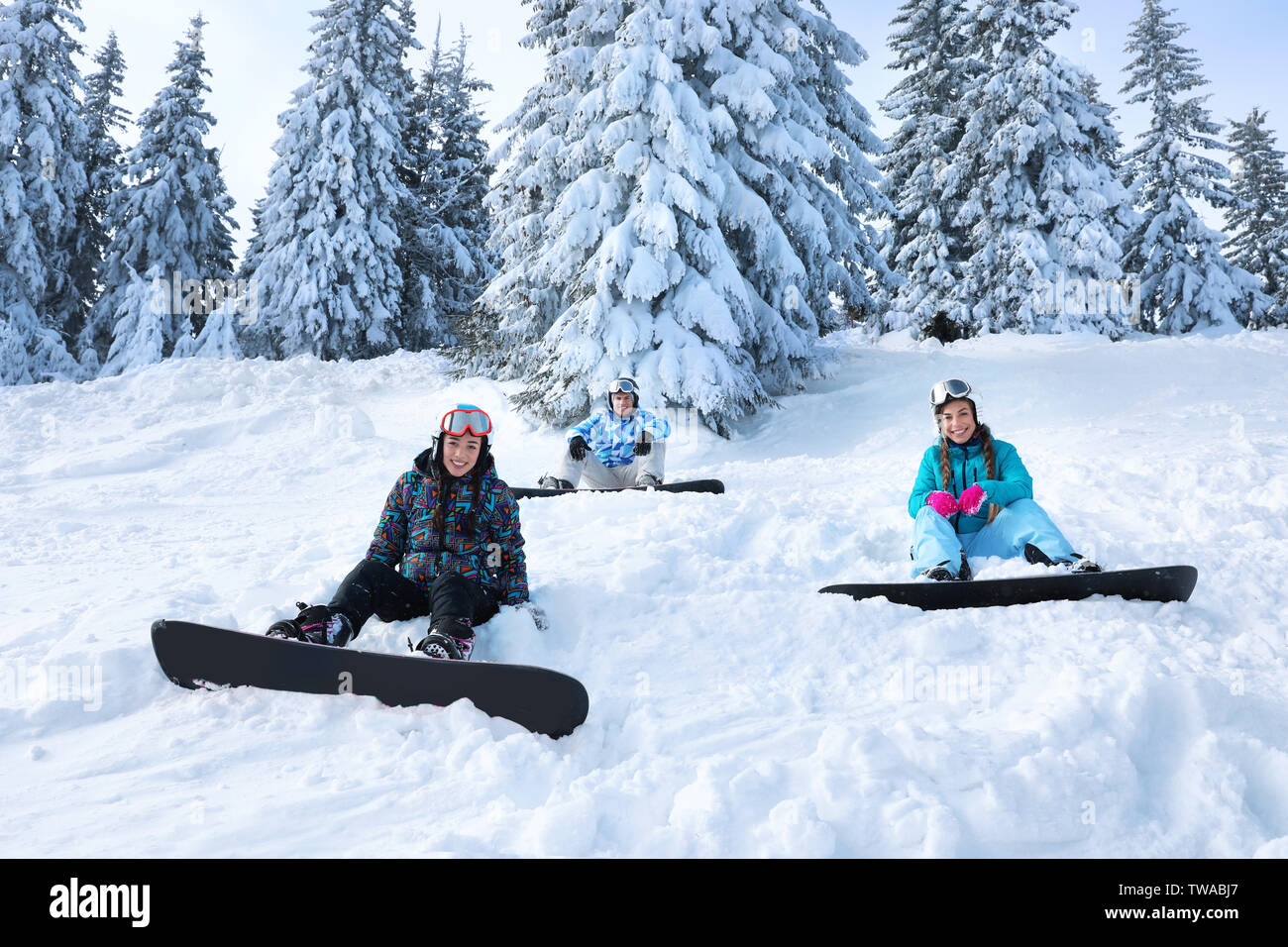 Snowboarders on ski piste at snowy resort. Winter vacation Stock Photo ...