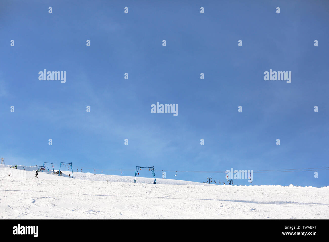 Snowy resort with ski lift on sunny day. Winter vacation Stock Photo ...