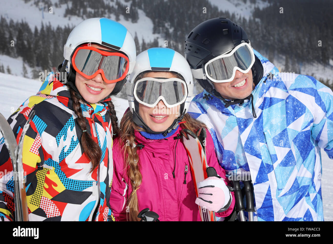 Happy friends on ski piste at snowy resort. Winter vacation Stock Photo ...