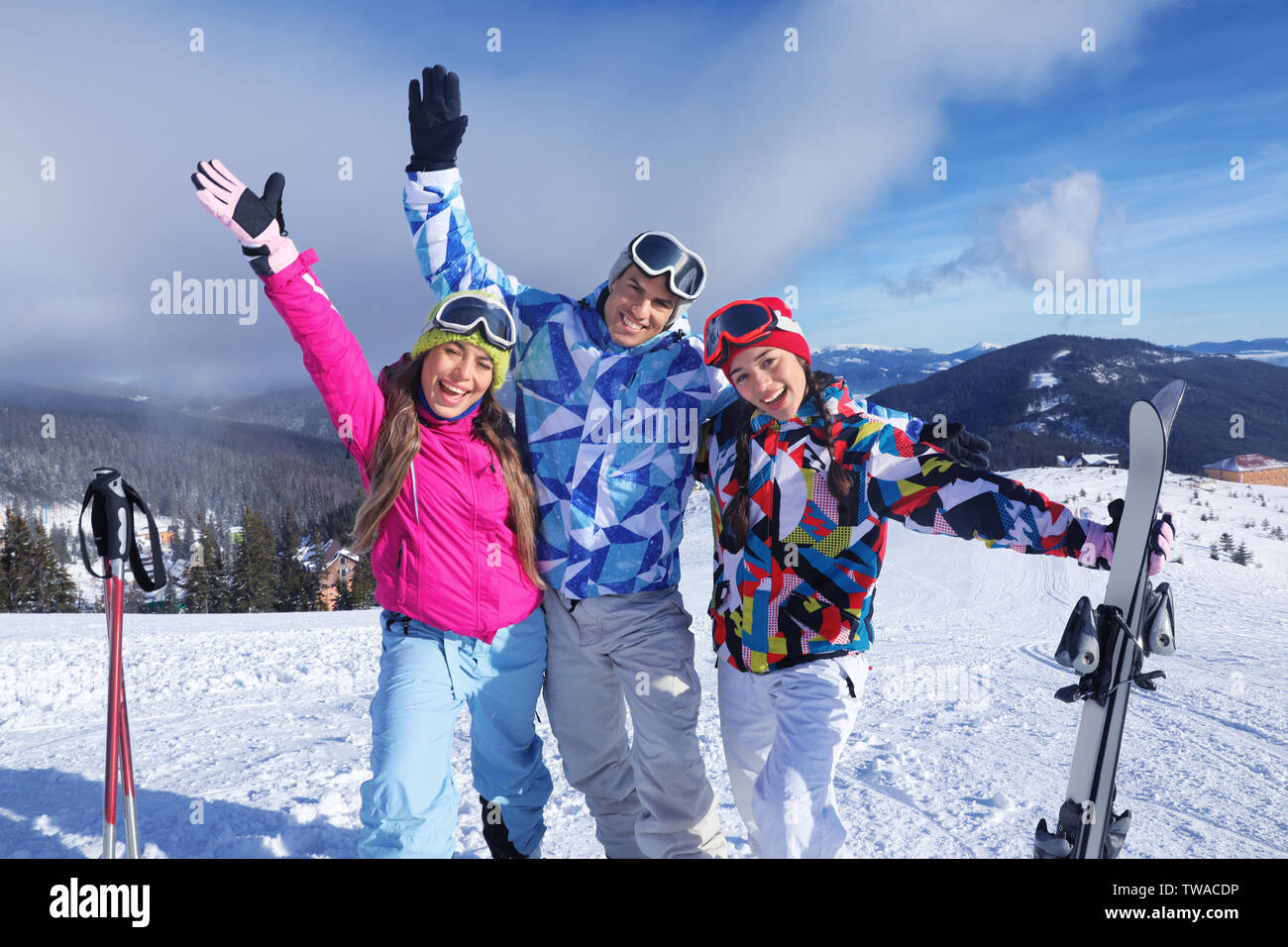 Happy friends on ski piste at snowy resort. Winter vacation Stock Photo ...