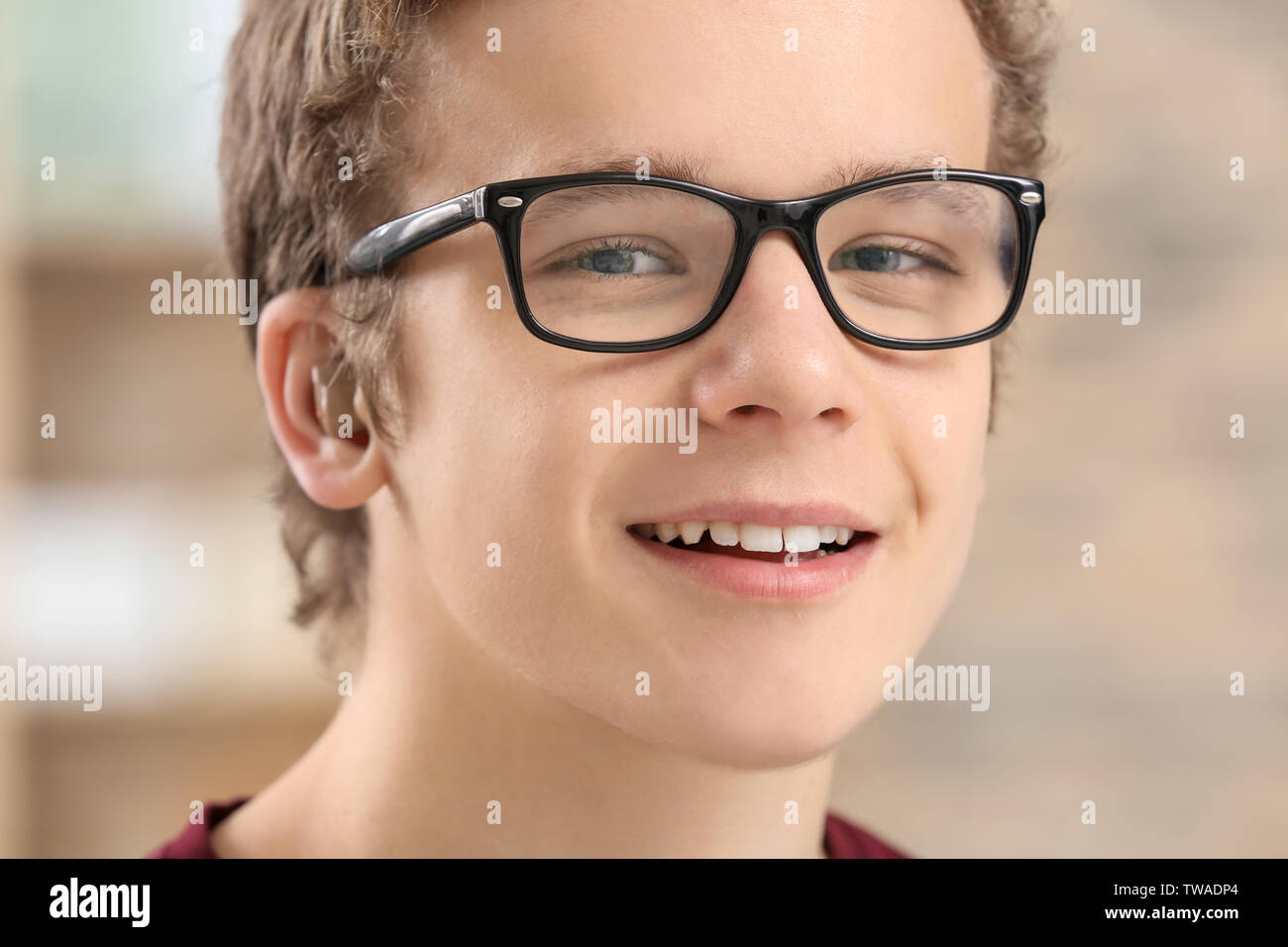 Teenage boy with hearing aid indoors Stock Photo - Alamy