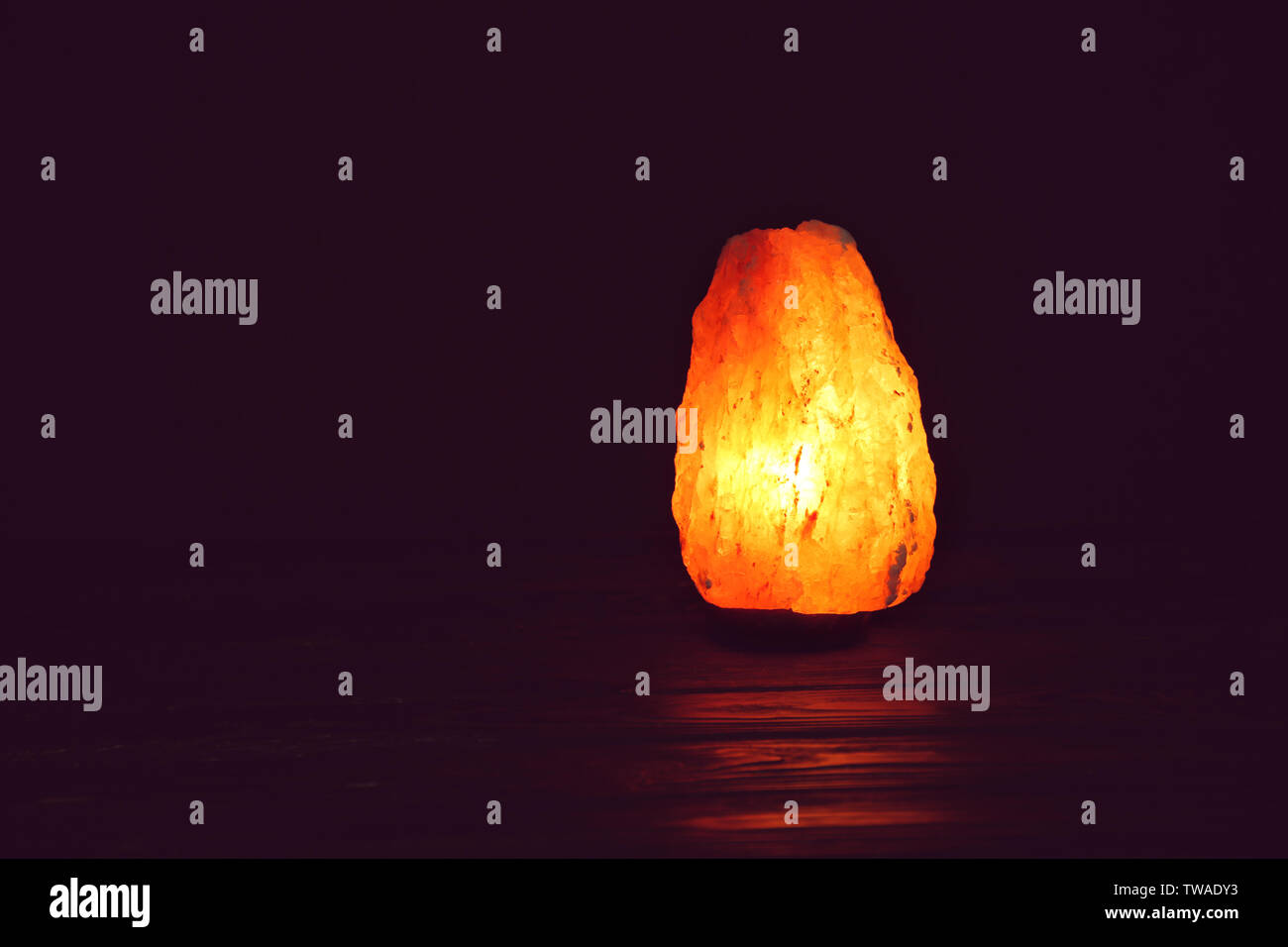 Himalayan salt lamp on black background Stock Photo - Alamy