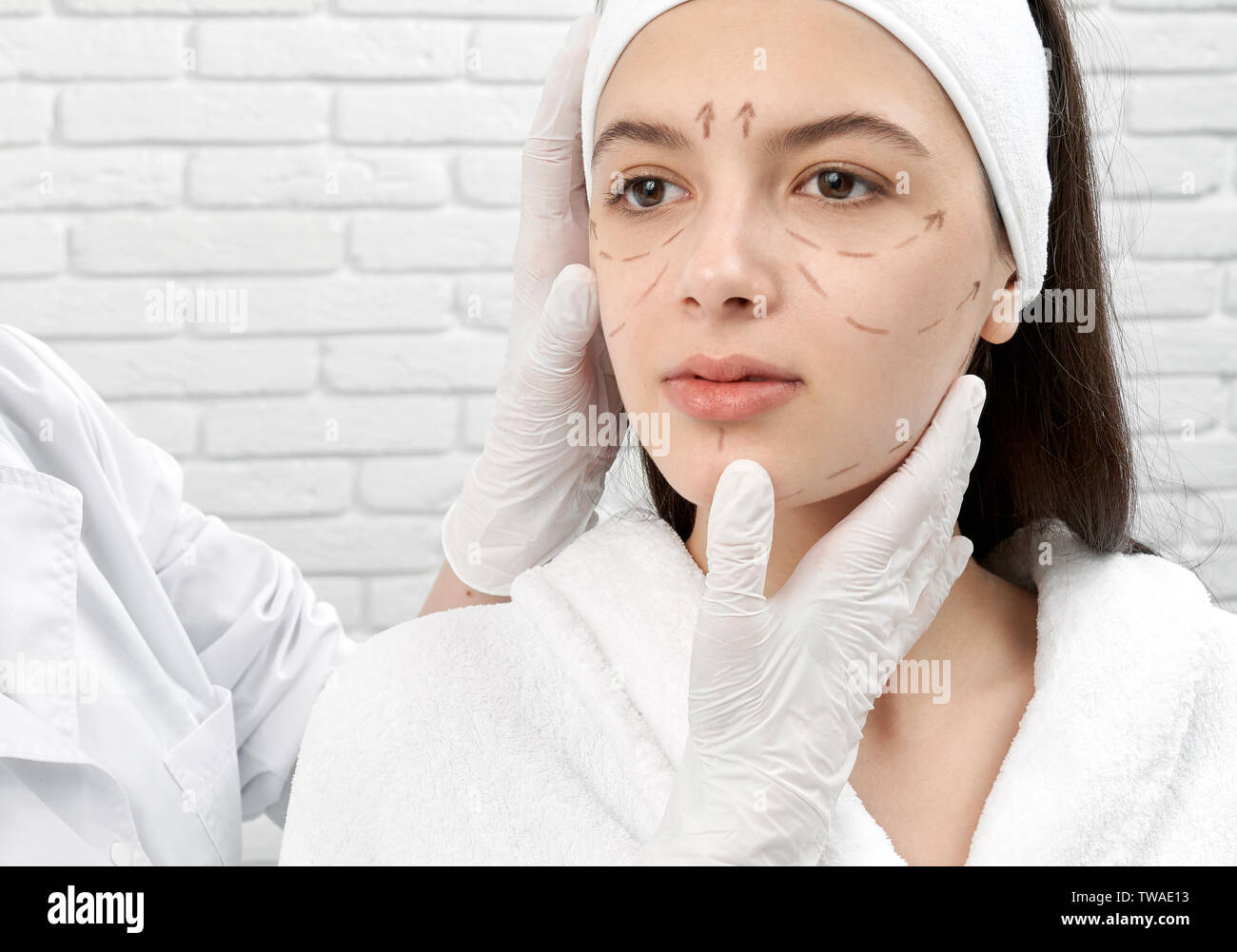 Front view of young female client looking forward while professional ...