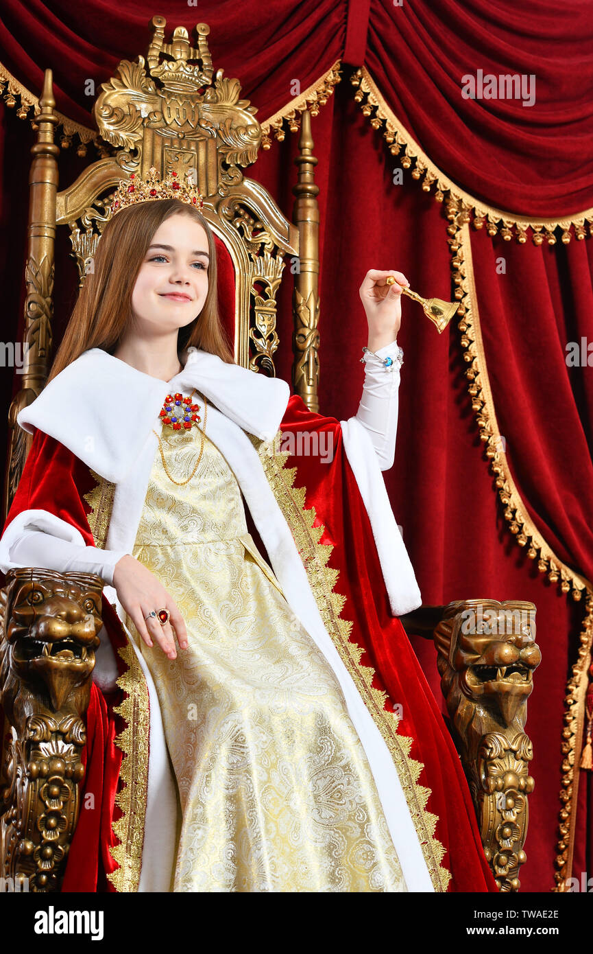 Portrait of beautiful princess with crown holding hand bell Stock Photo ...