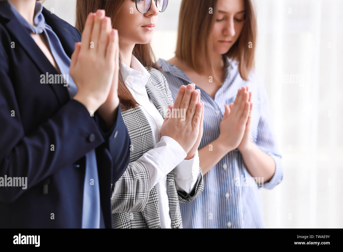 Religious women praying, indoors Stock Photo - Alamy