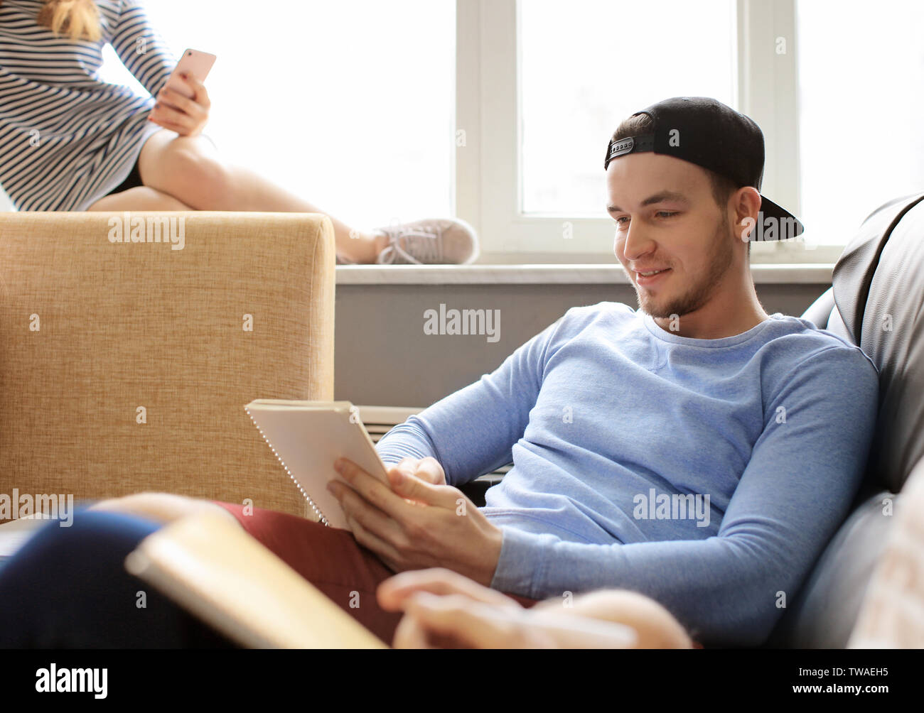 Male student resting in campus building Stock Photo - Alamy
