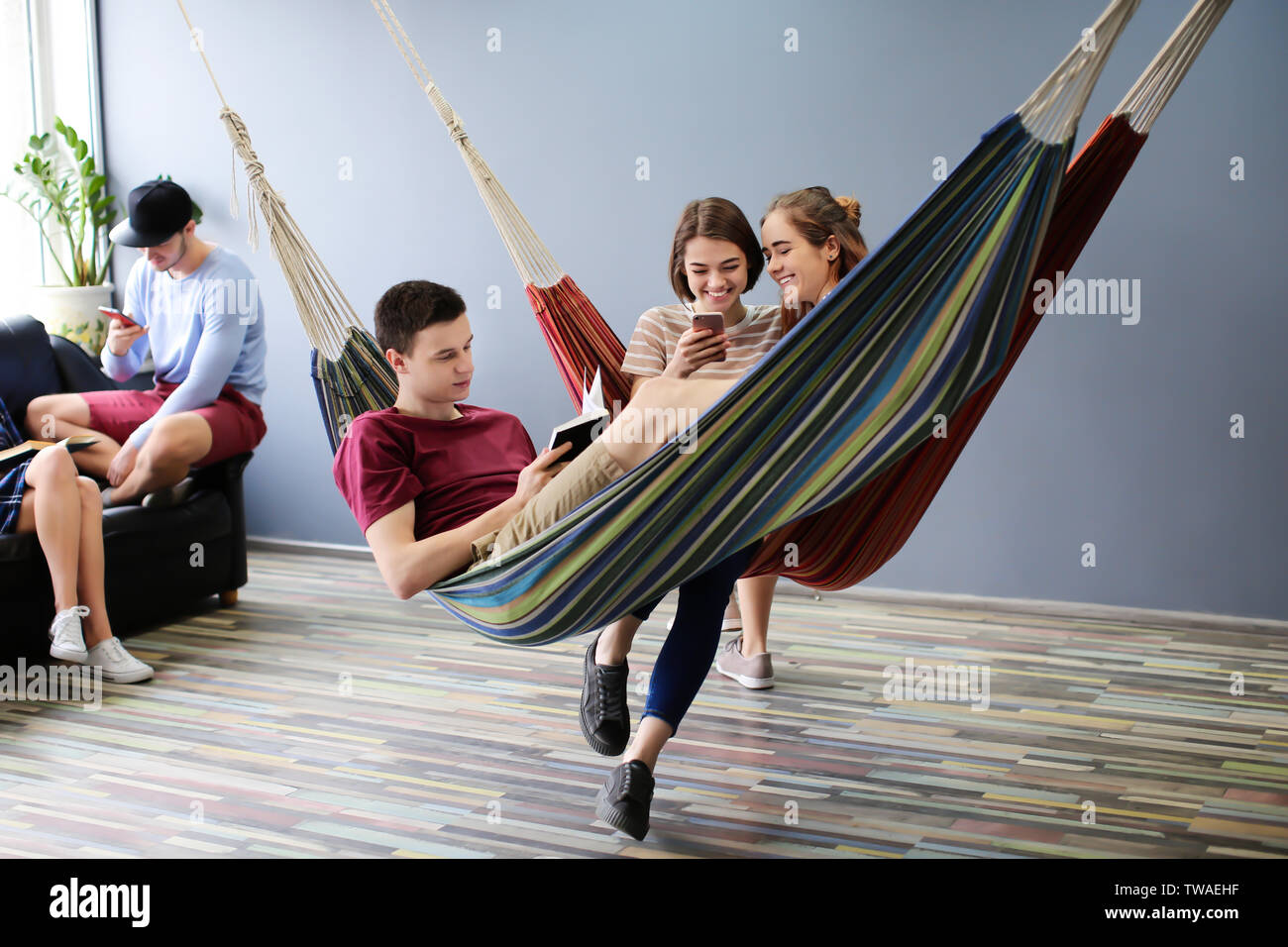 Students resting together in campus building Stock Photo - Alamy