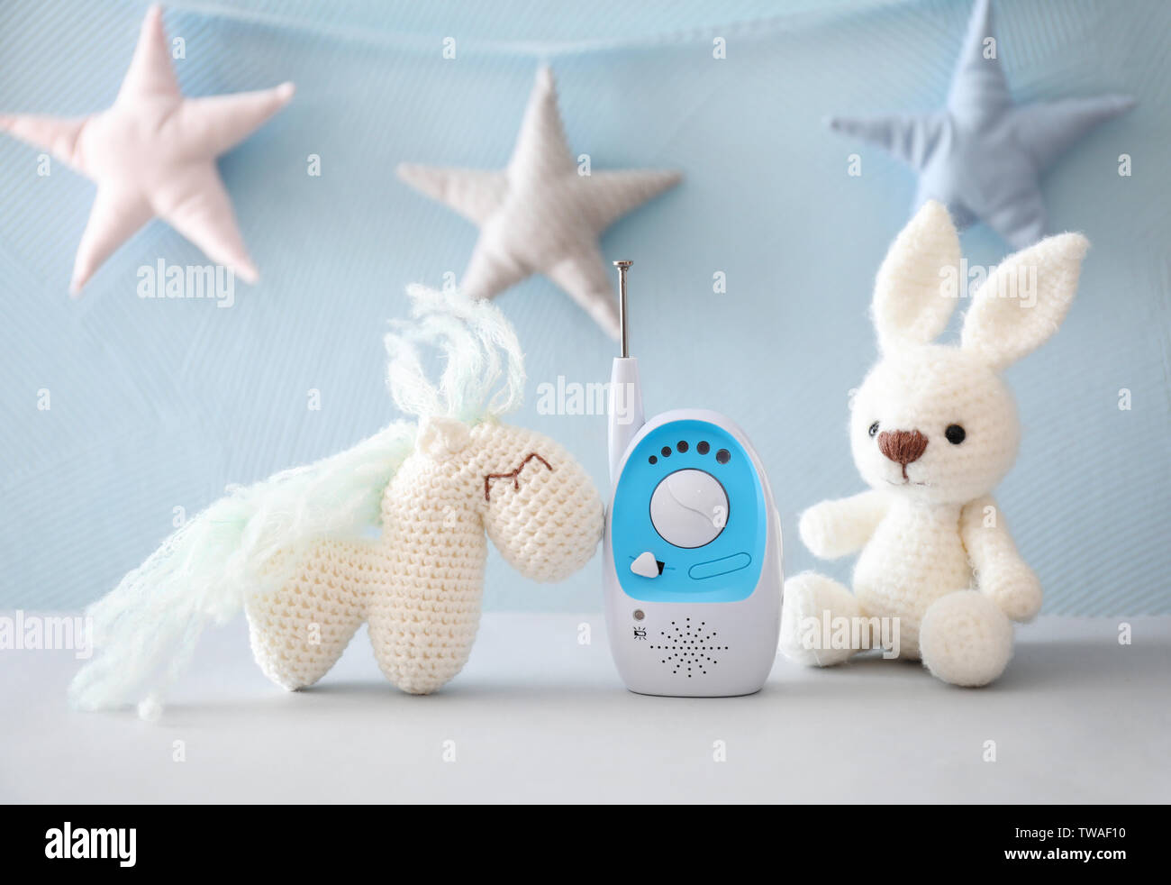 Baby monitor and toys on table Stock Photo - Alamy