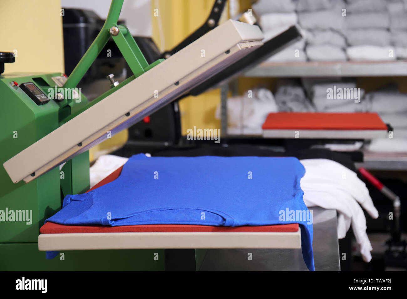 Modern printing machine with t-shirt at workplace Stock Photo - Alamy