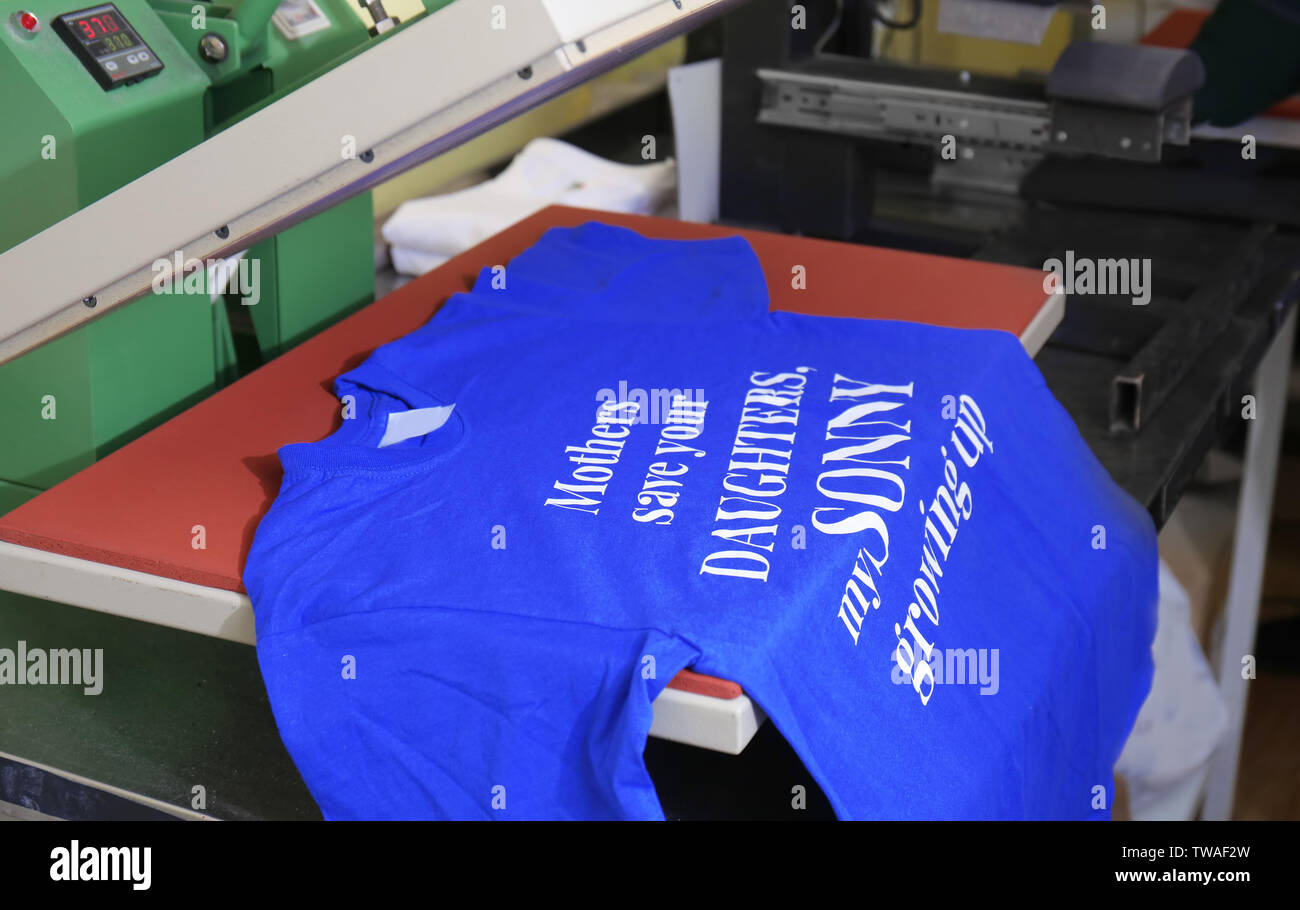 Modern printing machine with t-shirt at workplace Stock Photo - Alamy
