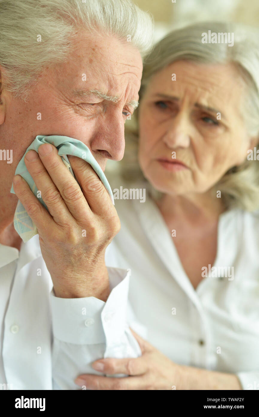 Sad senior couple, man holding hand on cheek with toothache Stock Photo ...