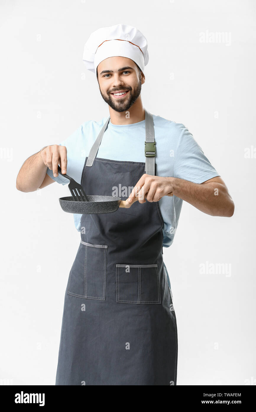 Handsome male chef with frying pan on white background Stock Photo - Alamy