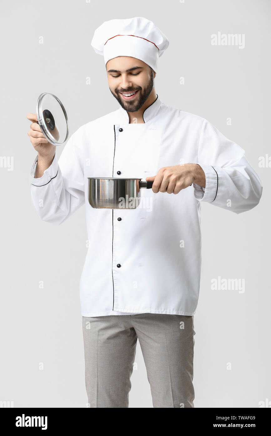 Handsome male chef with pot on white background Stock Photo - Alamy