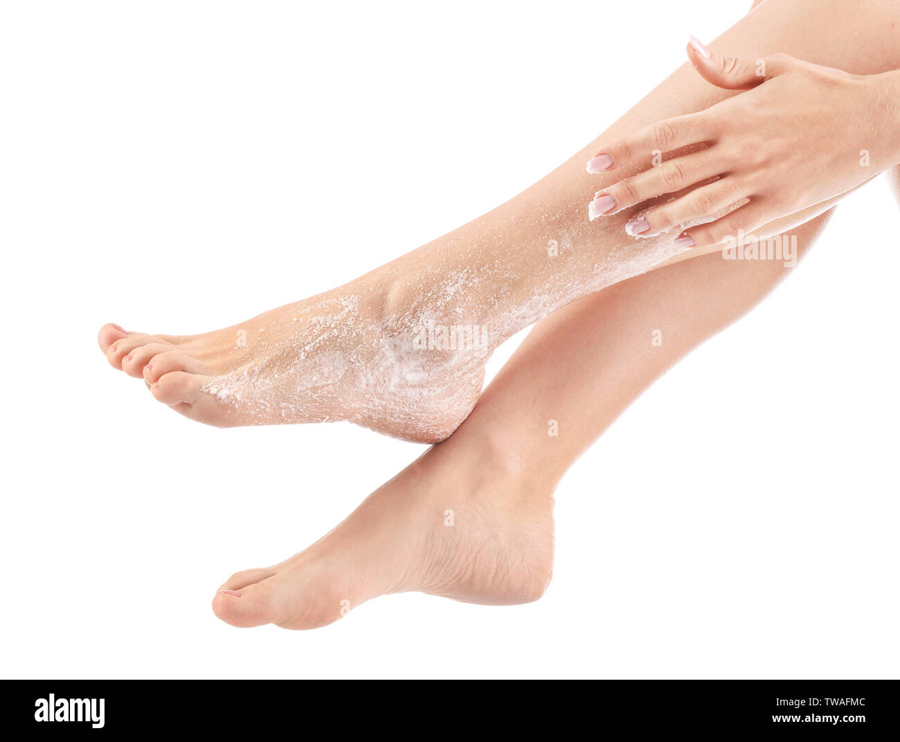 Young woman with body scrub on her legs against white background Stock ...