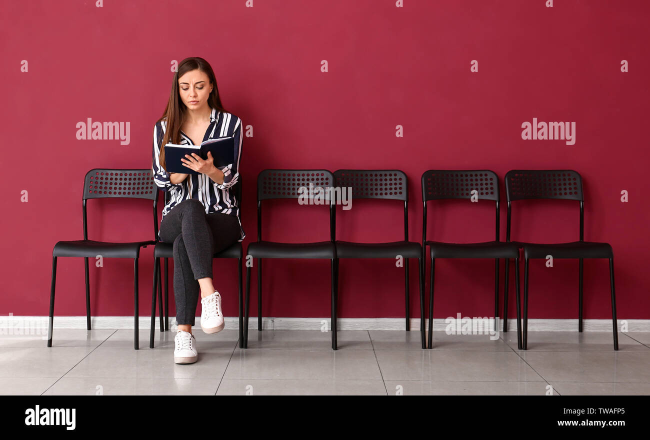Young woman waiting for job interview indoors Stock Photo - Alamy