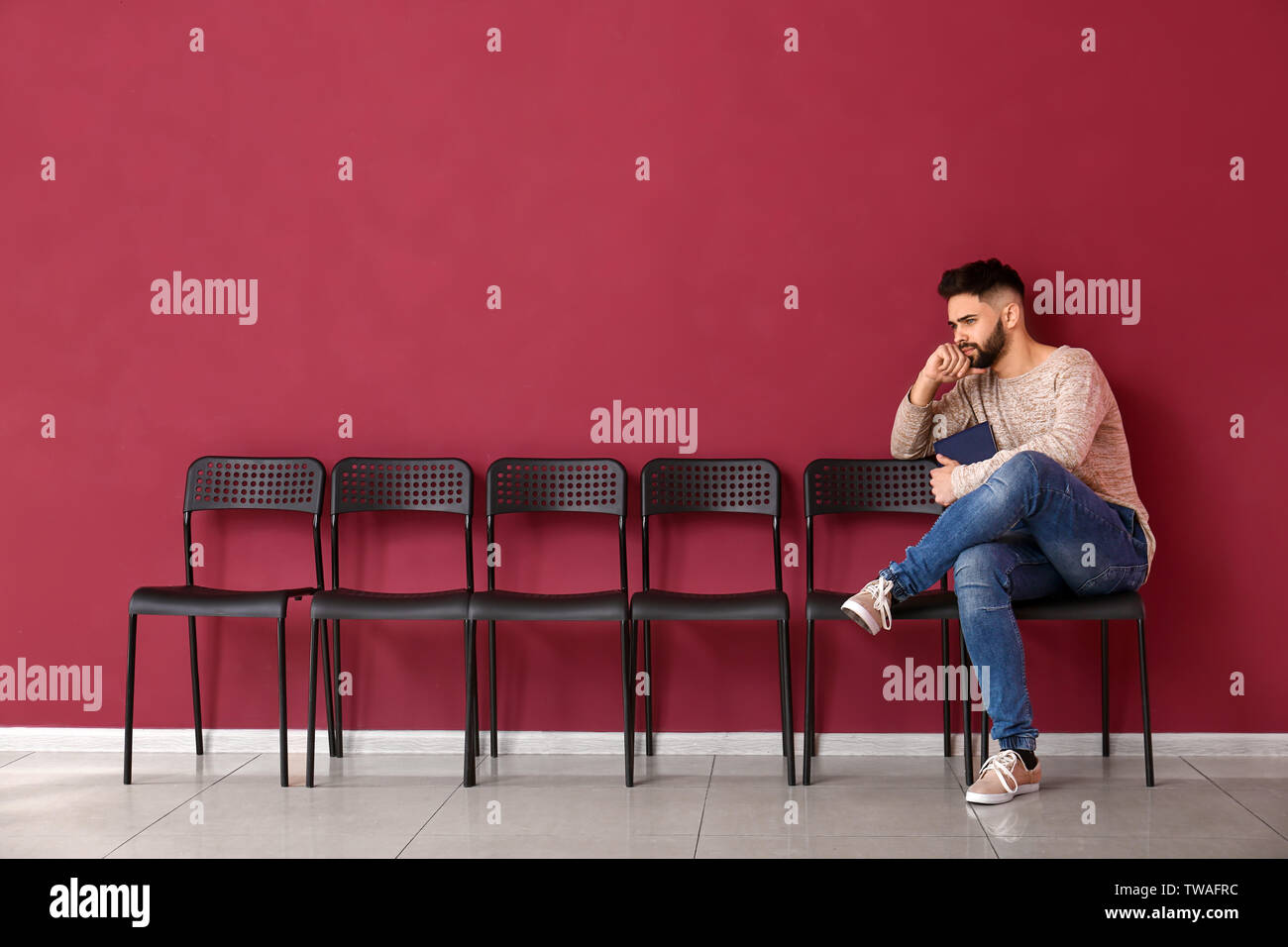 Young man waiting for job interview indoors Stock Photo - Alamy