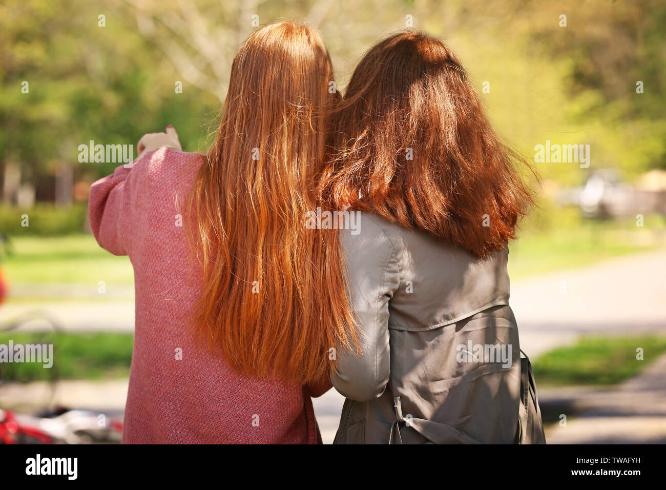 Beautiful young women in park, back view Stock Photo - Alamy