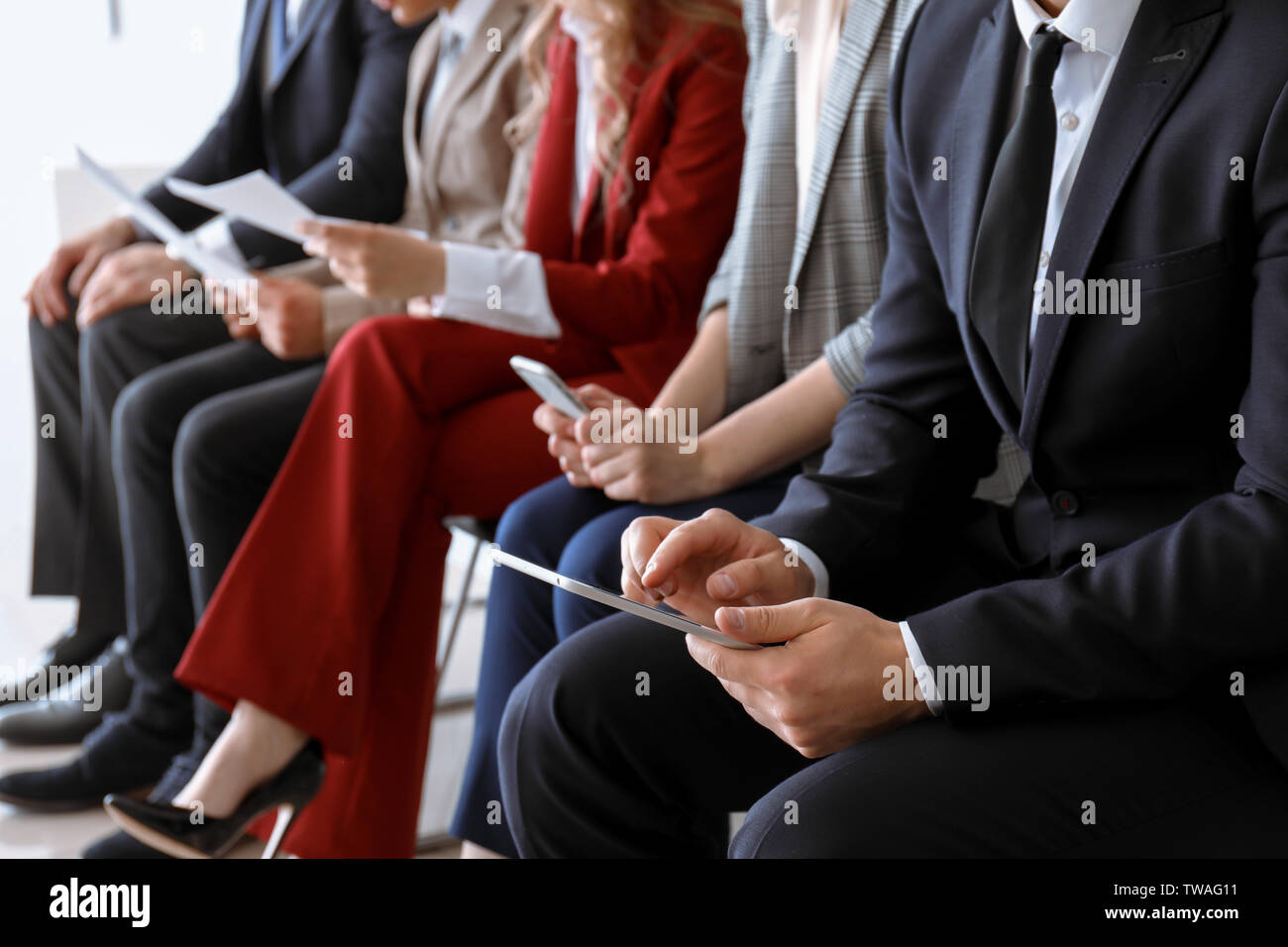 Young people waiting for job interview indoors Stock Photo - Alamy