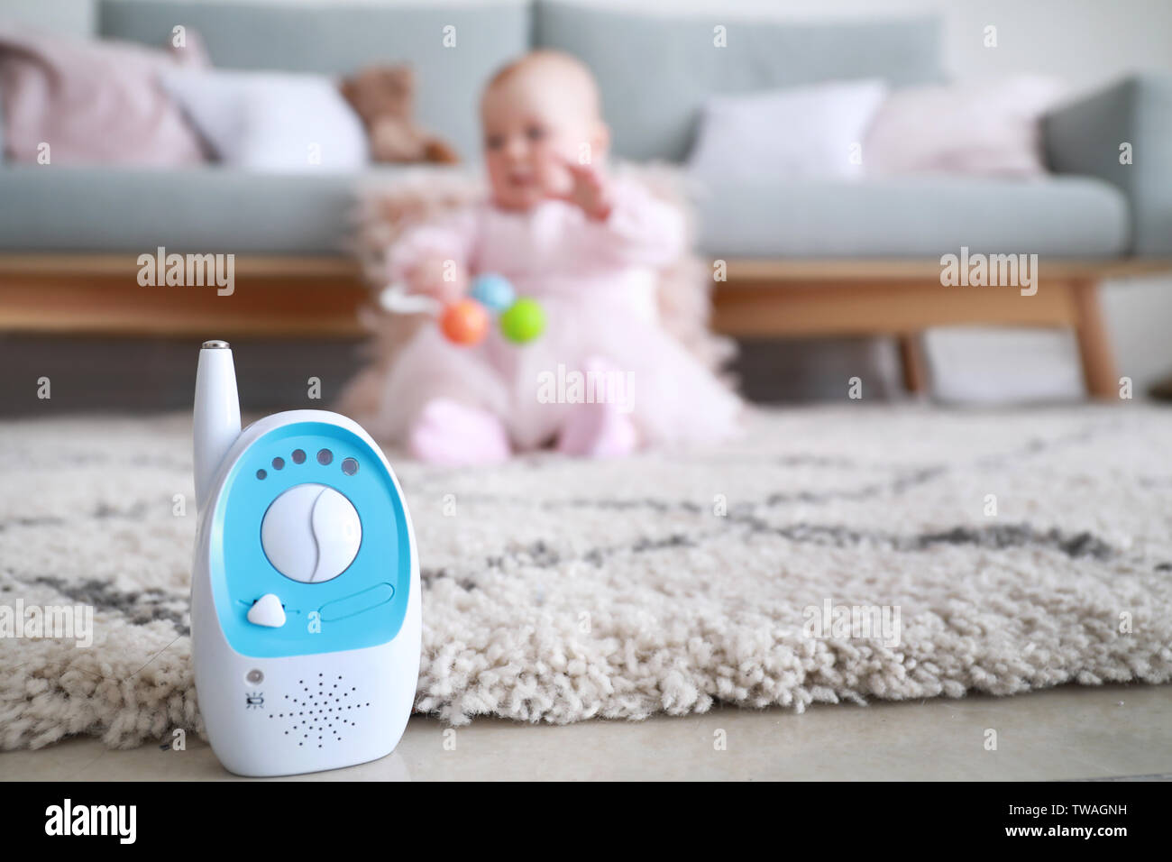Modern baby monitor on floor in room with little child Stock Photo - Alamy