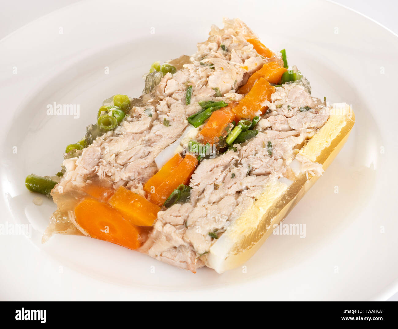 chicken terrine in front of white background Stock Photo - Alamy