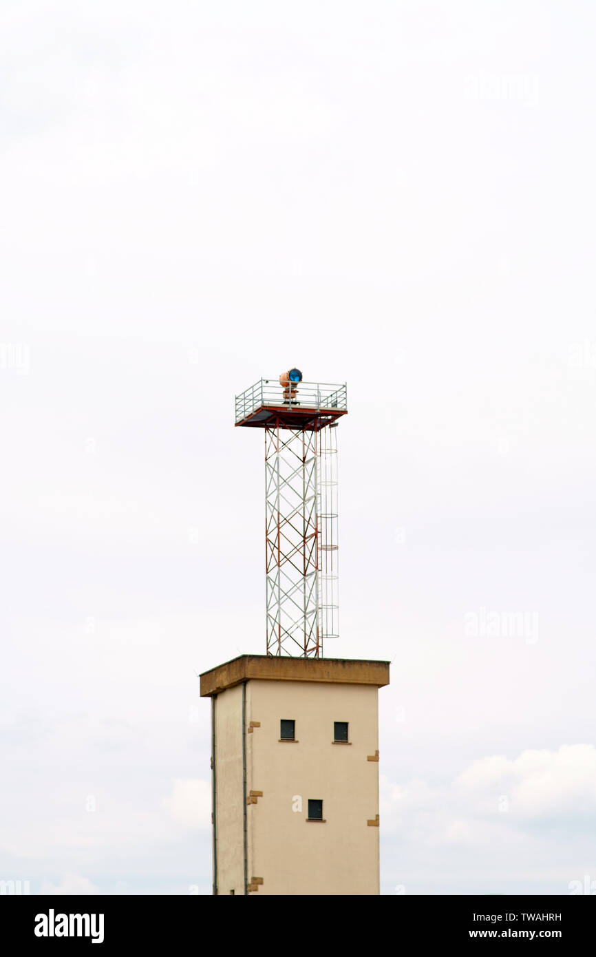 A disused watchtower with a floodlight on a disused airport area Stock ...