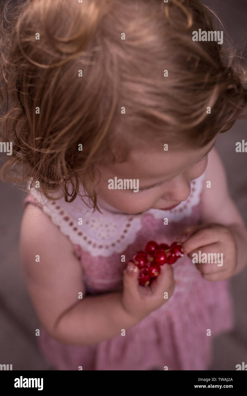 Kid tasting berries hi-res stock photography and images - Alamy
