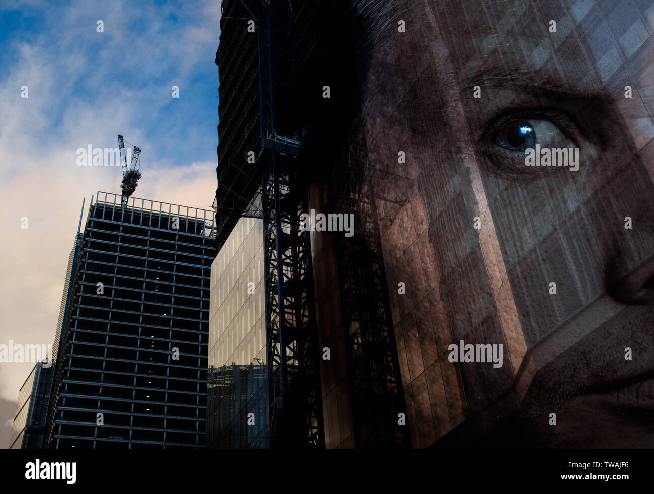 A successful businessman looks over construction of new industrial ...