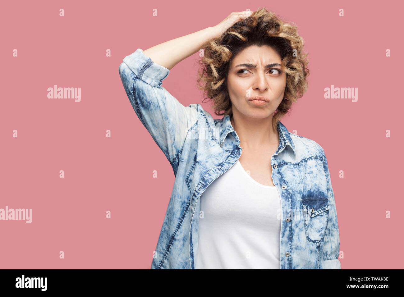 Woman scratching head young confused hi-res stock photography and ...