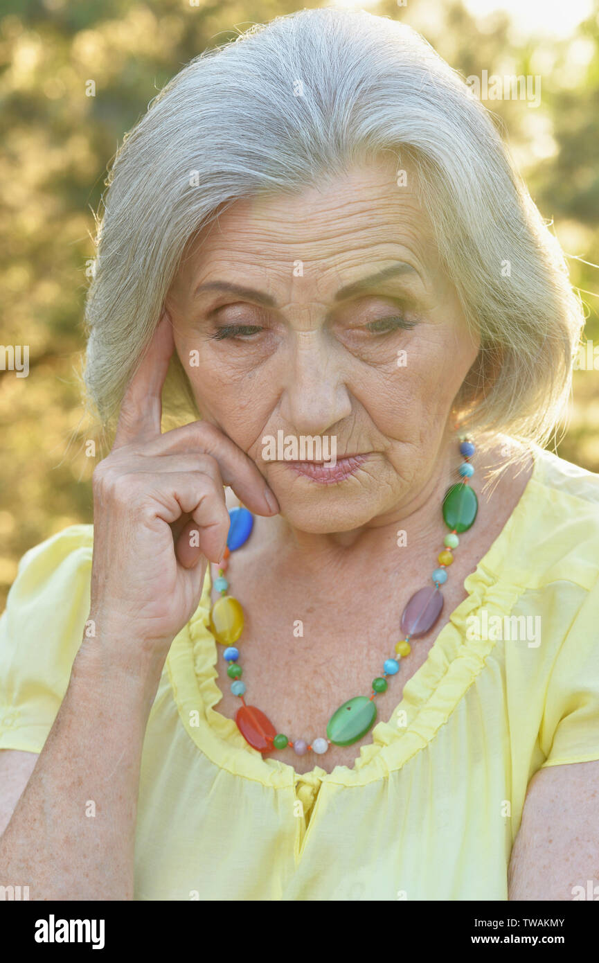 Portrait of sad senior beautiful woman posing in spring park Stock ...