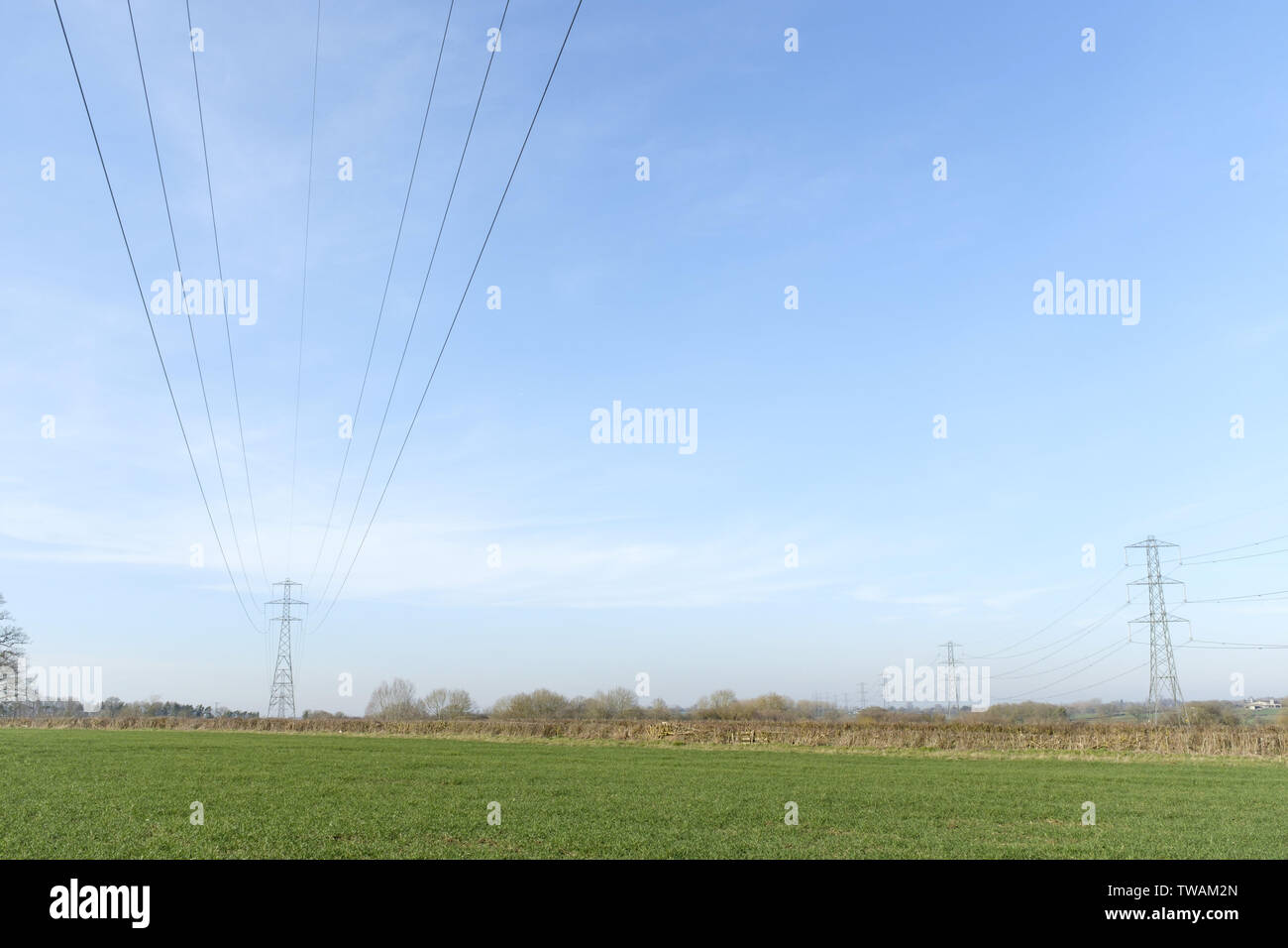 Overhead power lines and electricity pylons on the National Grid in ...