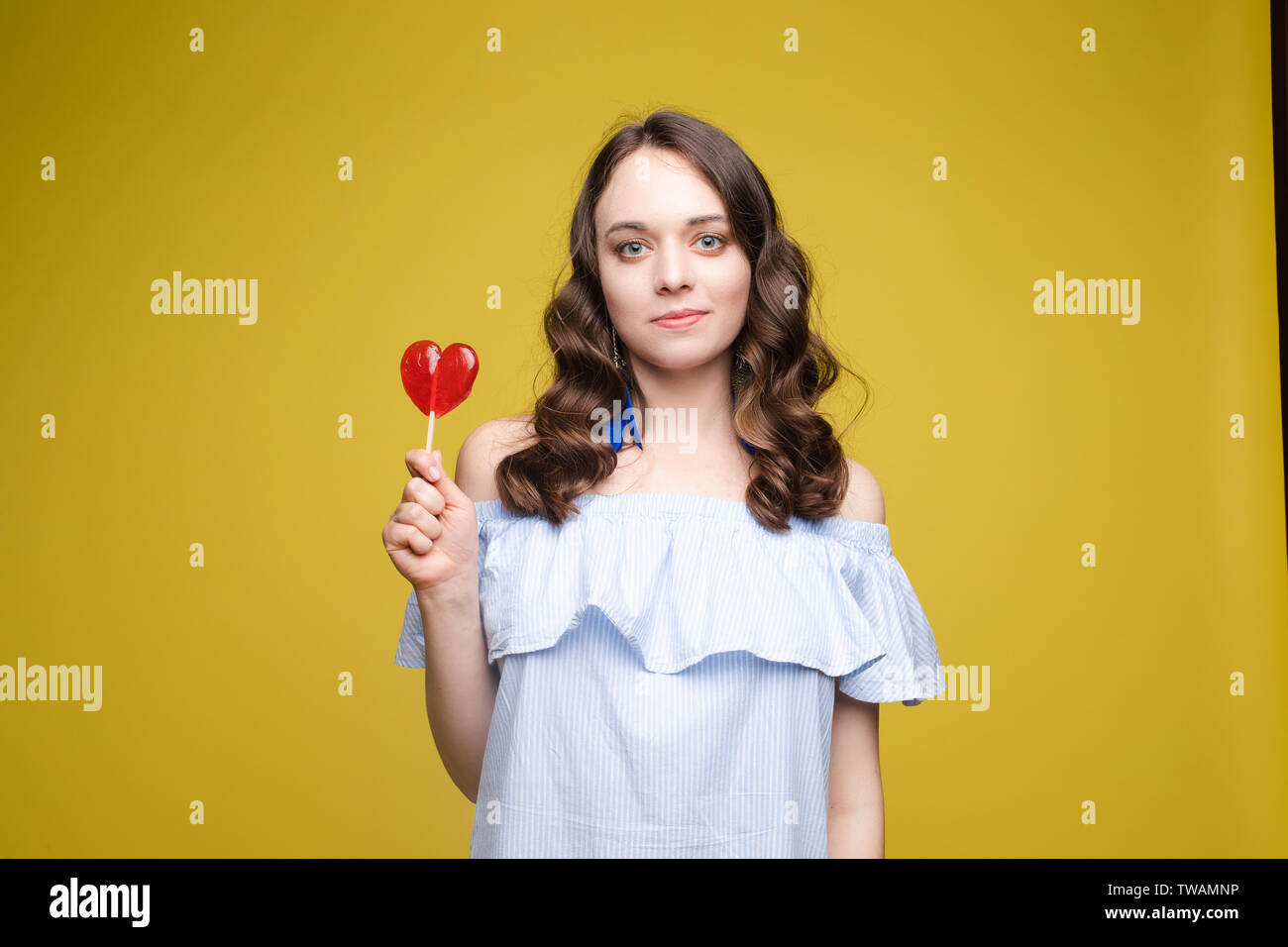 Seductive woman like sweet doll with candy Stock Photo - Alamy