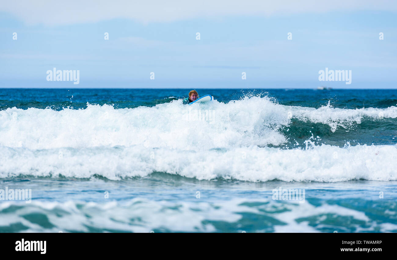 Surfer woman with surfboard is paddling on the wave. Girl in surfing ...