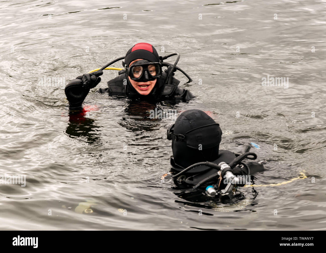 scuba diving in a mountain lake, practicing techniques for emergency ...