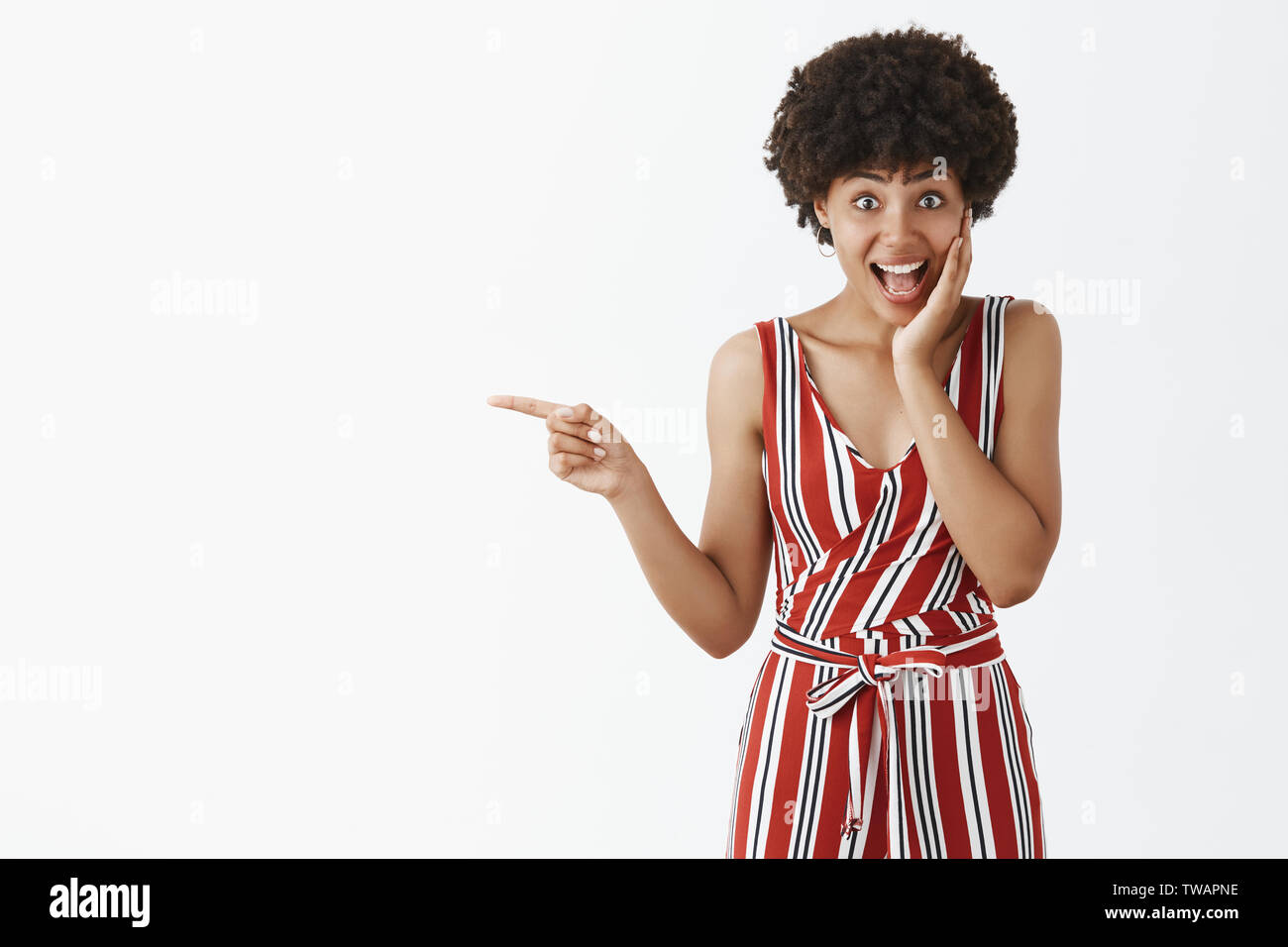 Beautiful woman pointing cheek hi-res stock photography and images - Alamy