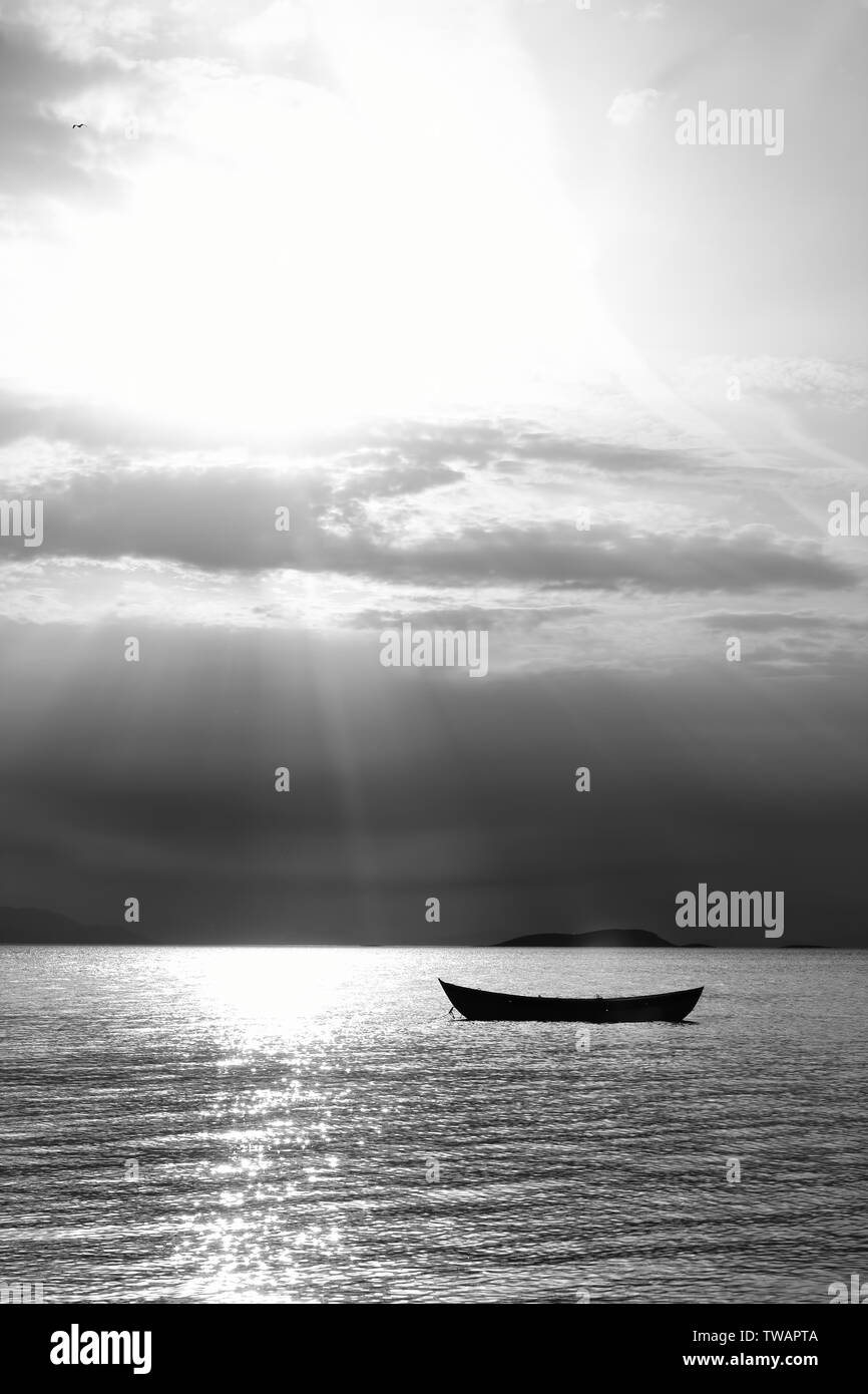 Sunset in the sea with a boat. A picture of a small boat with a ...
