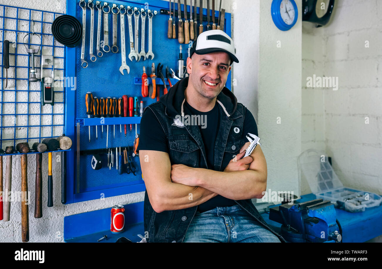 Mechanic posing with a motorcycle Stock Photo - Alamy