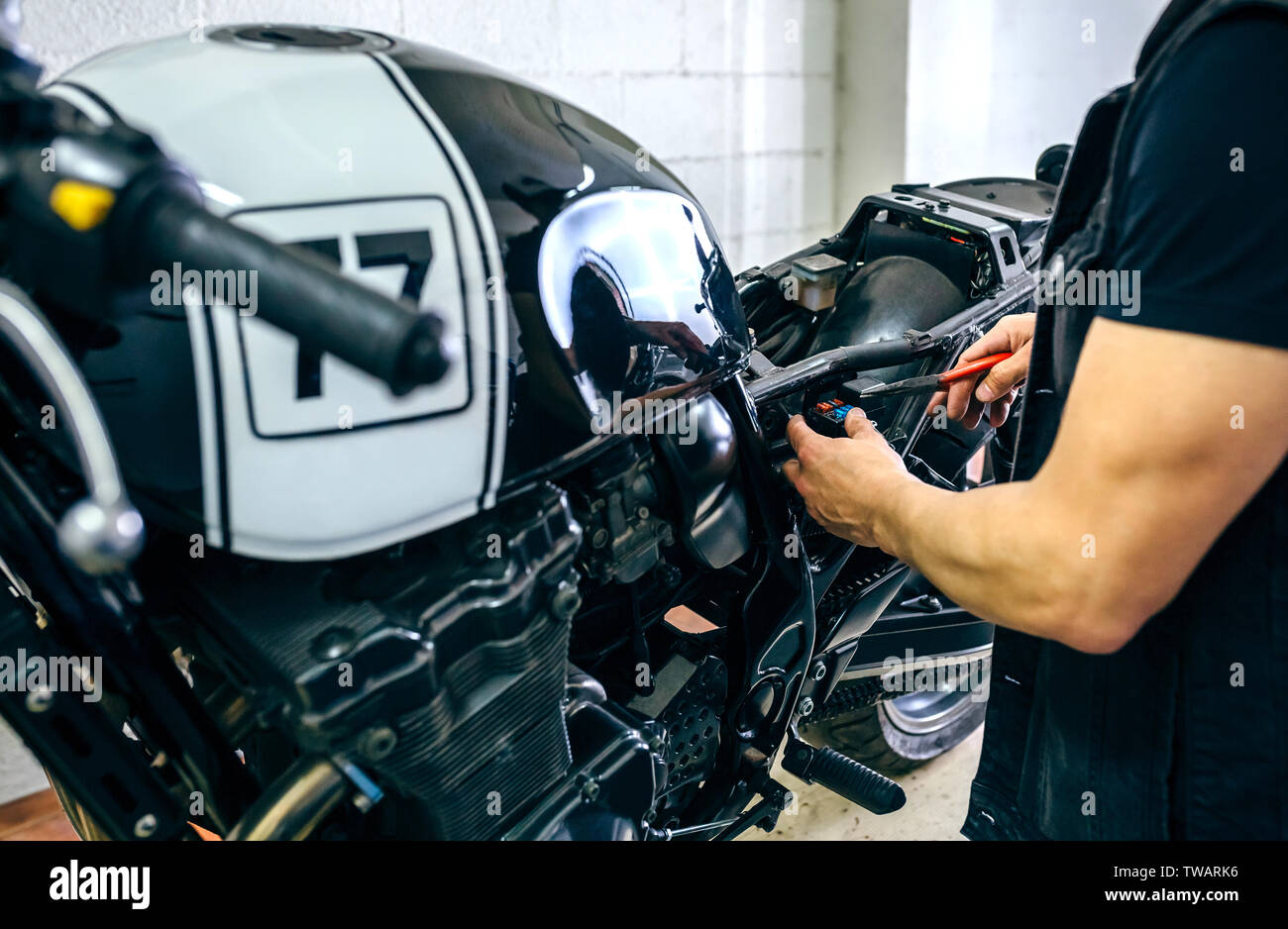 Motorcycle mechanic changing a fuse Stock Photo - Alamy