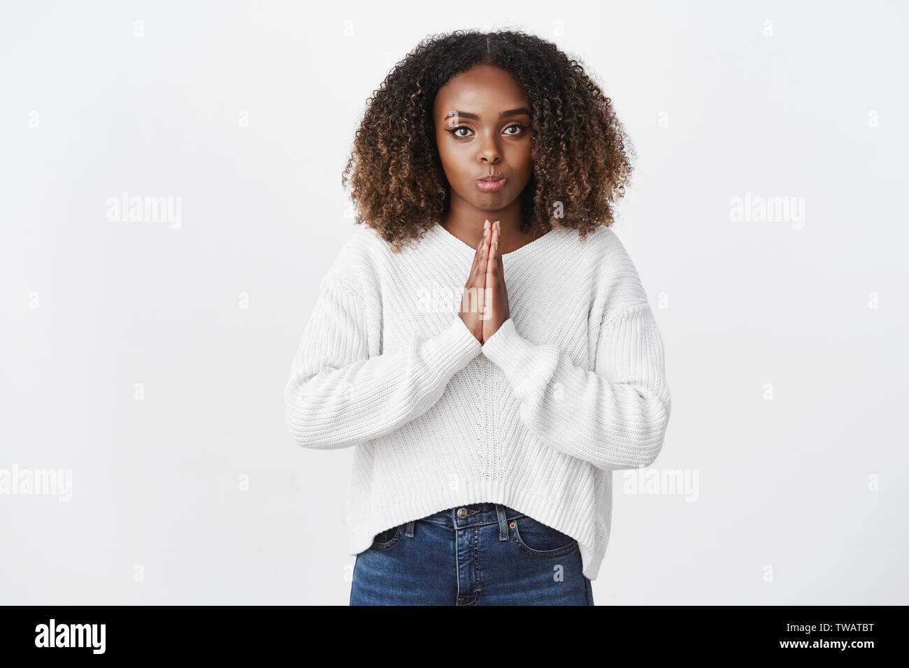 African american girl showing silly face asking favour pouting lips ...