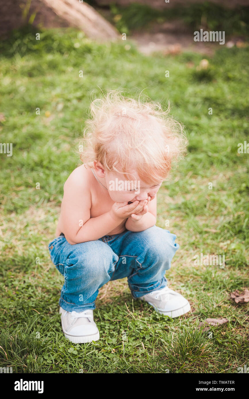 Cute little boy at summer day on green lawn Stock Photo - Alamy