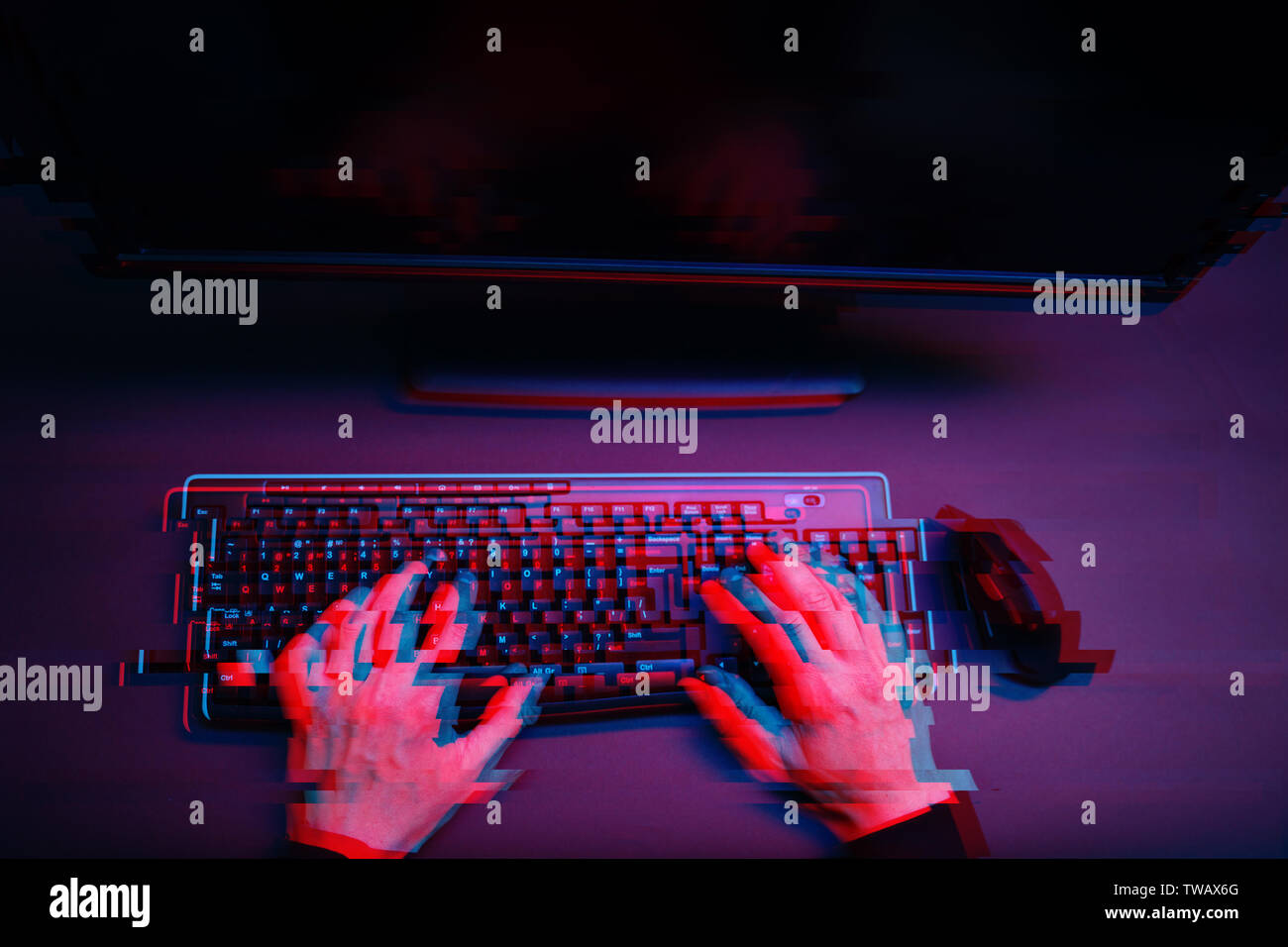 Hacker In The Hood Working With Computer Typing Text In Dark Room Image With Glitch Effect