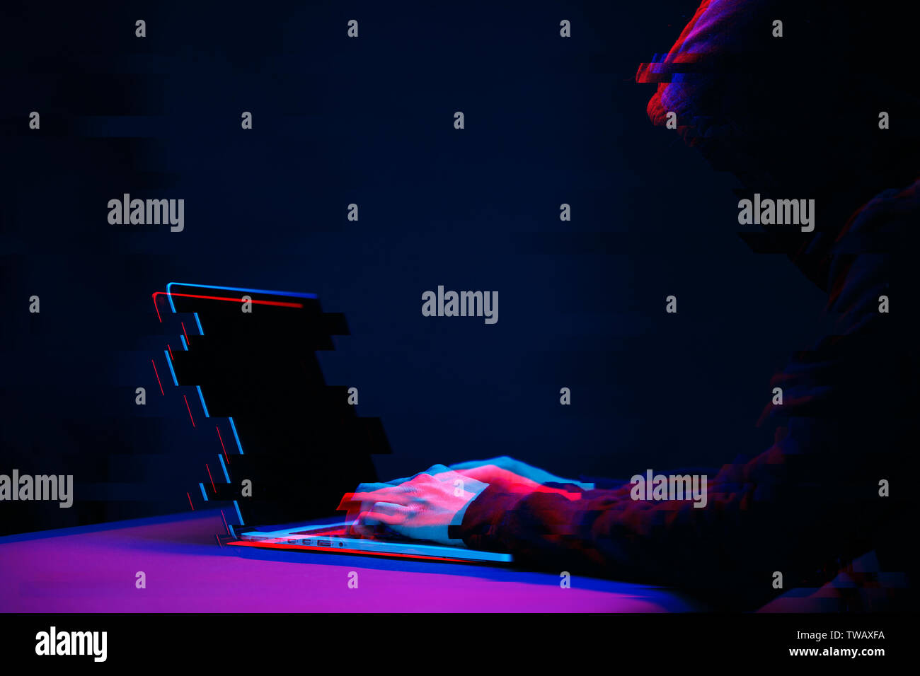 Hacker in the hood working with laptop typing text in dark room. Image with glitch effect Stock ...
