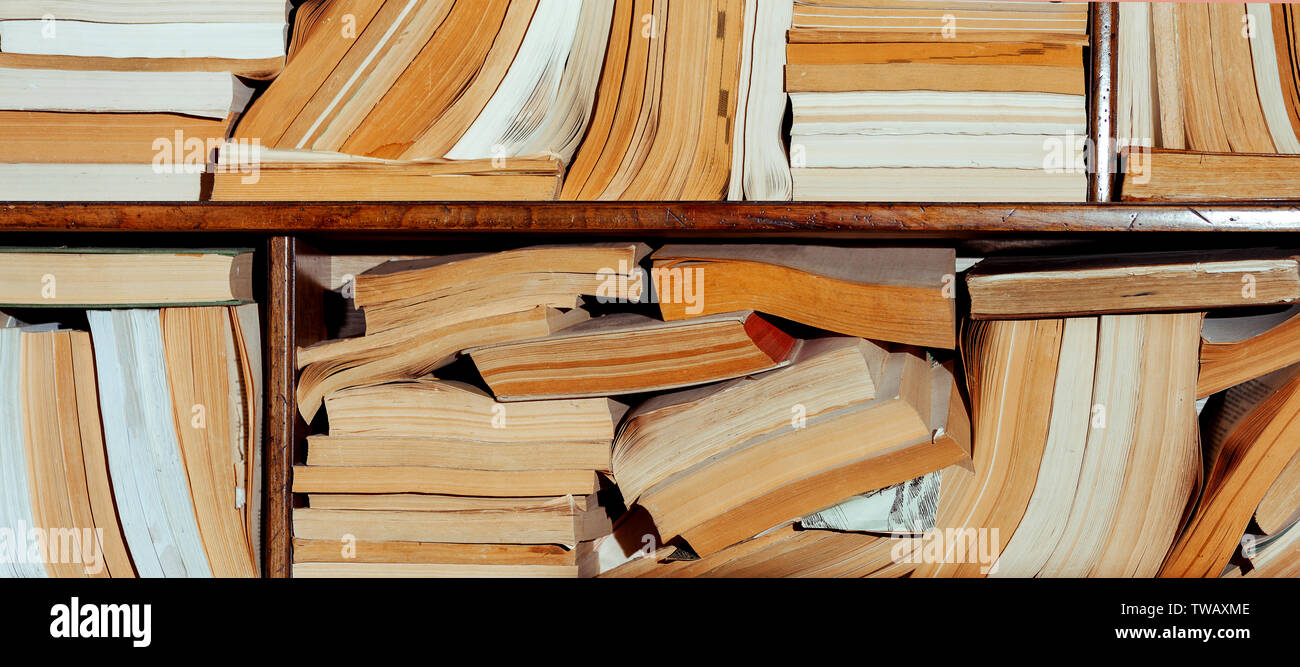 Random various books scattered on the bookshelf. Lot of old books in a ...