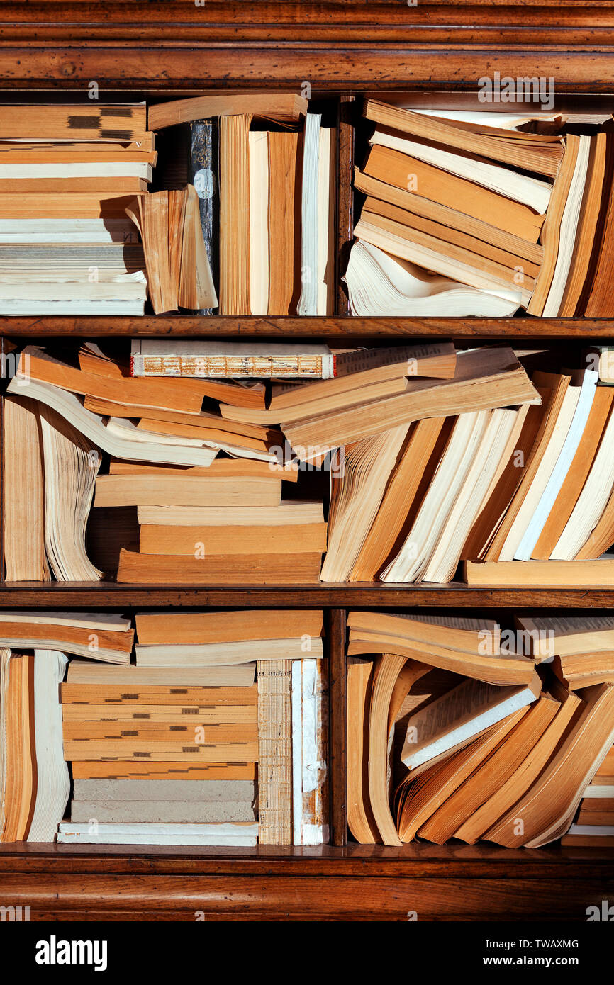 Random various books scattered on the bookshelf. Lot of old books in a ...