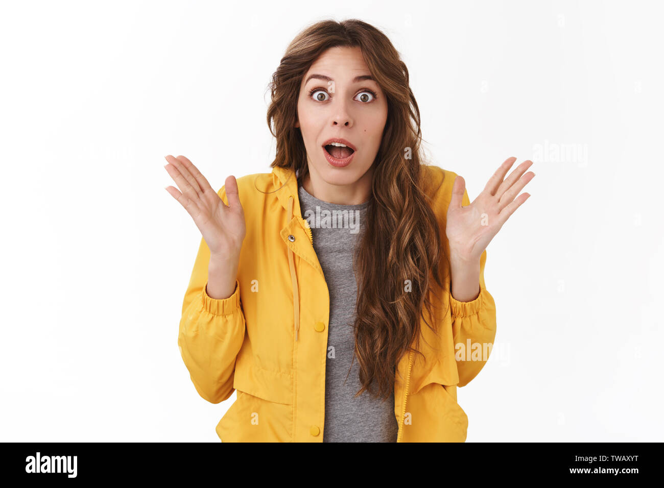 Surprised emotive wondered girl curly chestnut hairstyle drop jaw ...