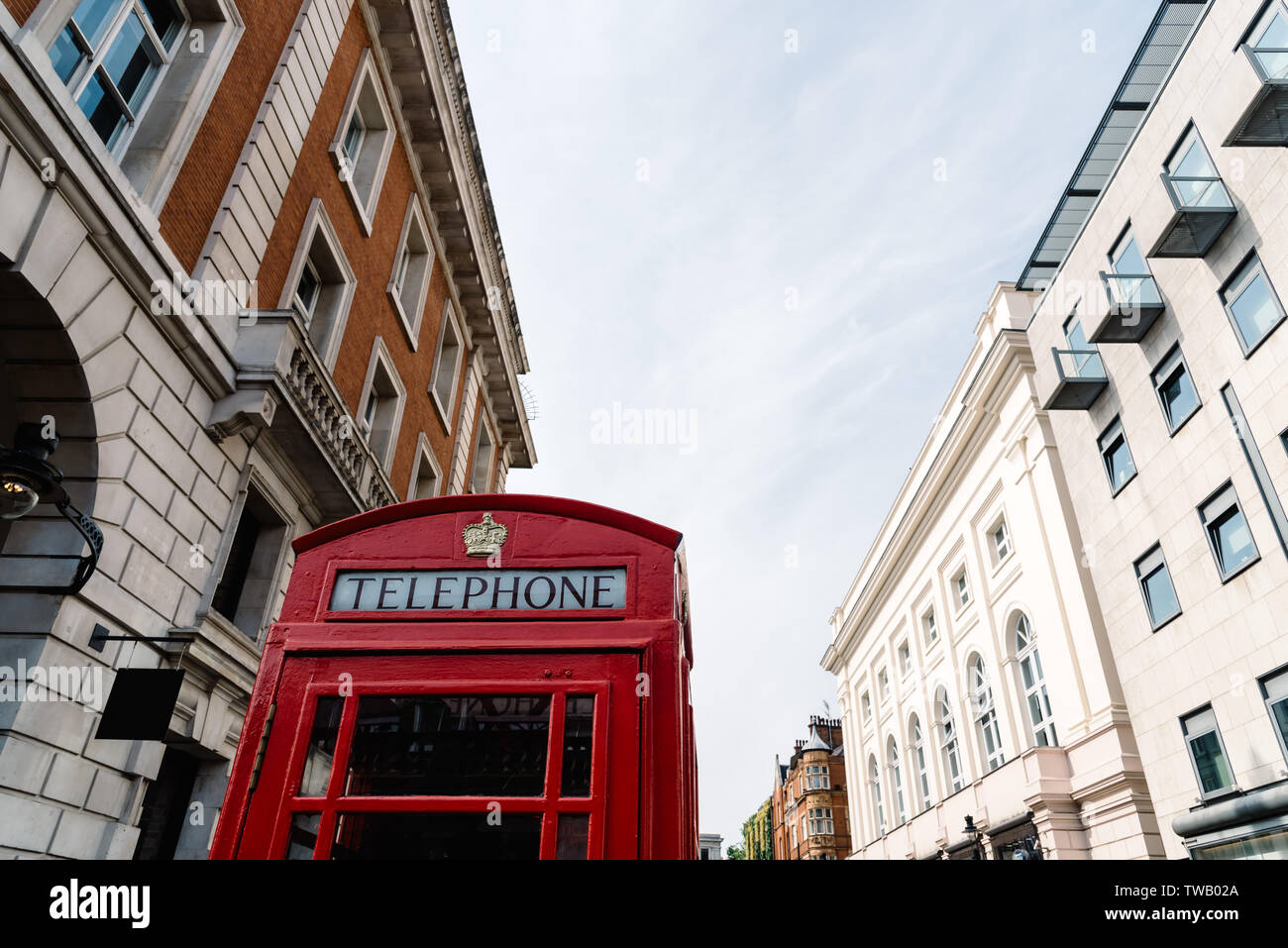 Traditional red telephone box in London, England, UK. Low angle view ...